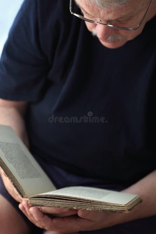 Older Man Reads a Book in His Lap Stock Photo - Image of natural ...