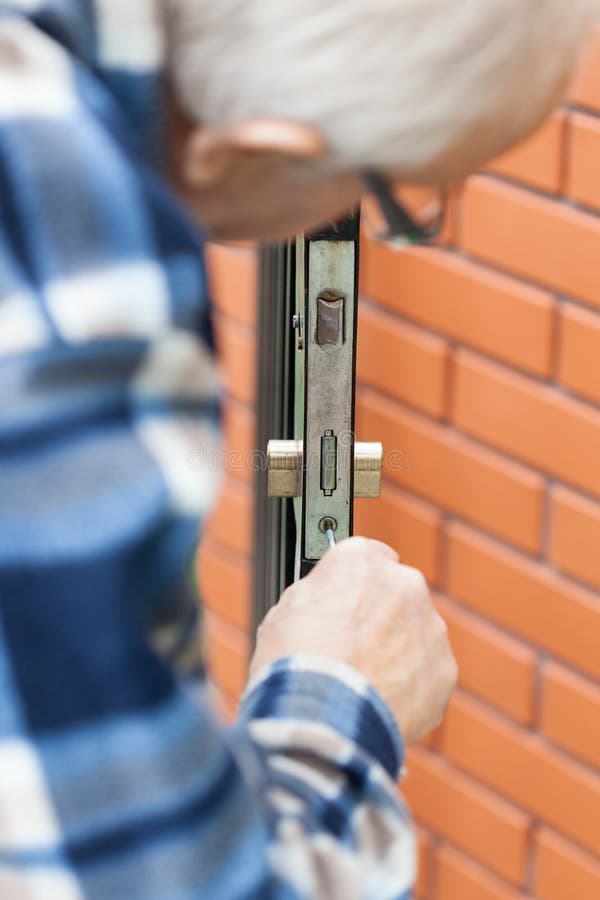 Older Man Repairing a Door Lock Stock Photo - Image of professional ...