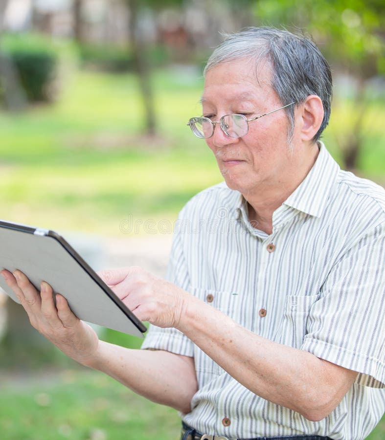 Older man use tablet stock photo. Image of nature, middle - 150248546