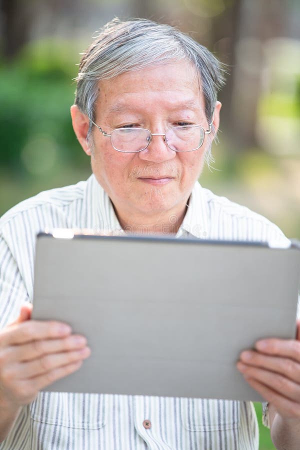Older man use tablet stock image. Image of outdoor, health - 150248755