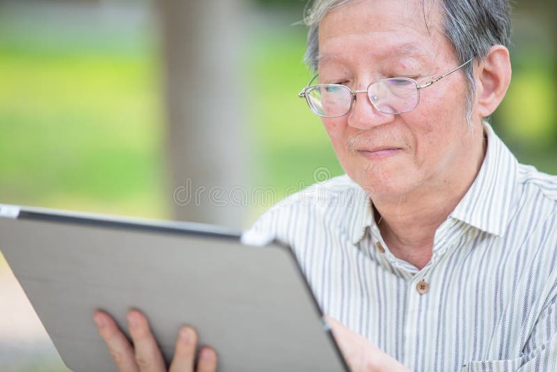 Older man use tablet stock image. Image of media, asian - 151084933