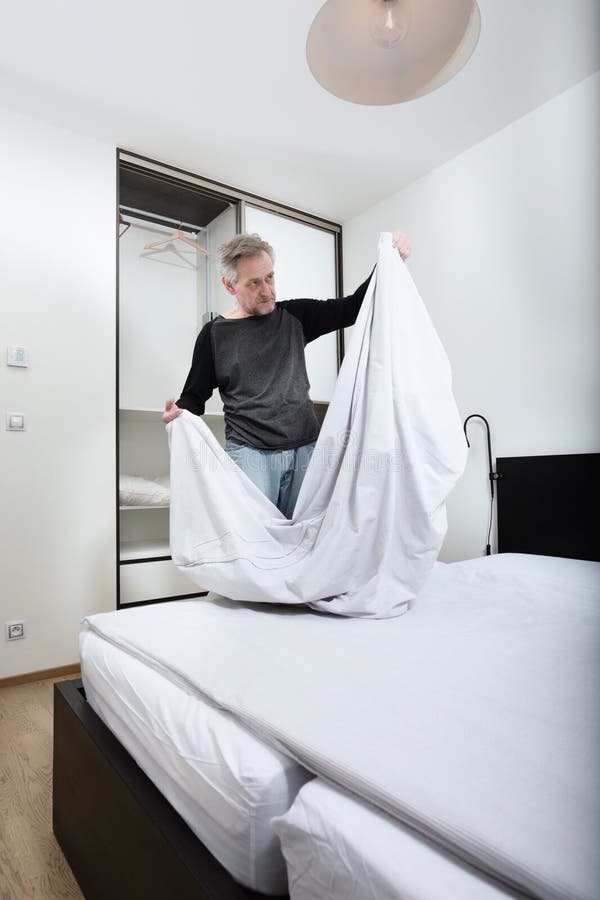 Senior Working on Bed Making in His Home Bedroom for Good Sleeping ...