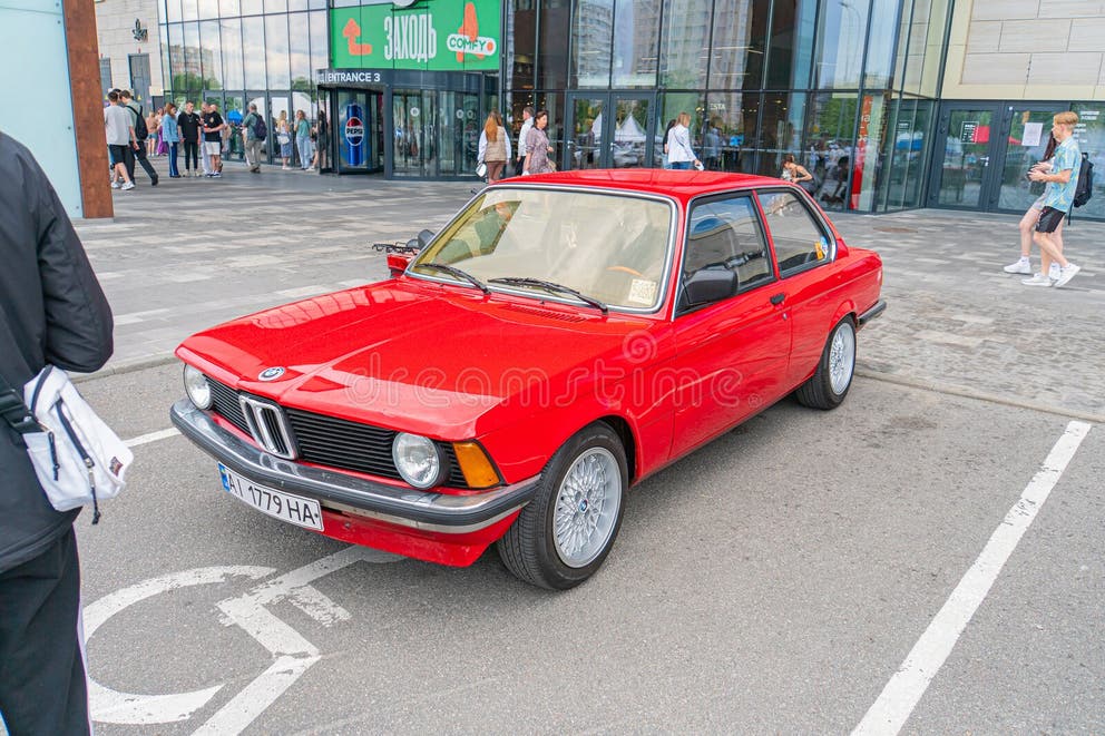 An Older-model Red Car with Visible Modifications Including Large ...