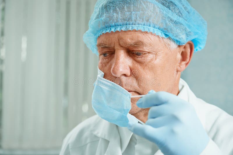 Older Surgeon Takes Off His Protective Mask Stock Image - Image of ...