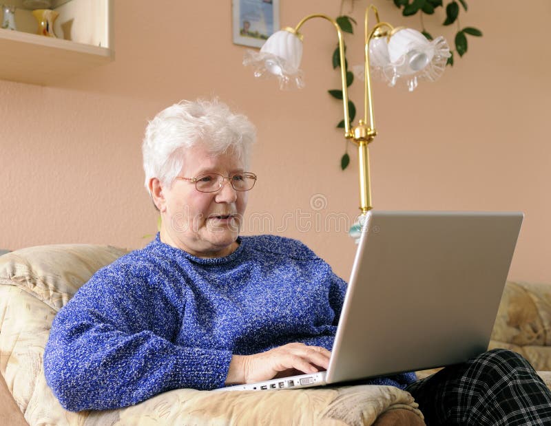 Older woman on laptop stock photo. Image of living, email - 18148890