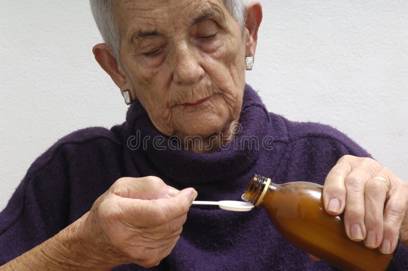 Older woman taking syrup stock image. Image of medicament - 63660103