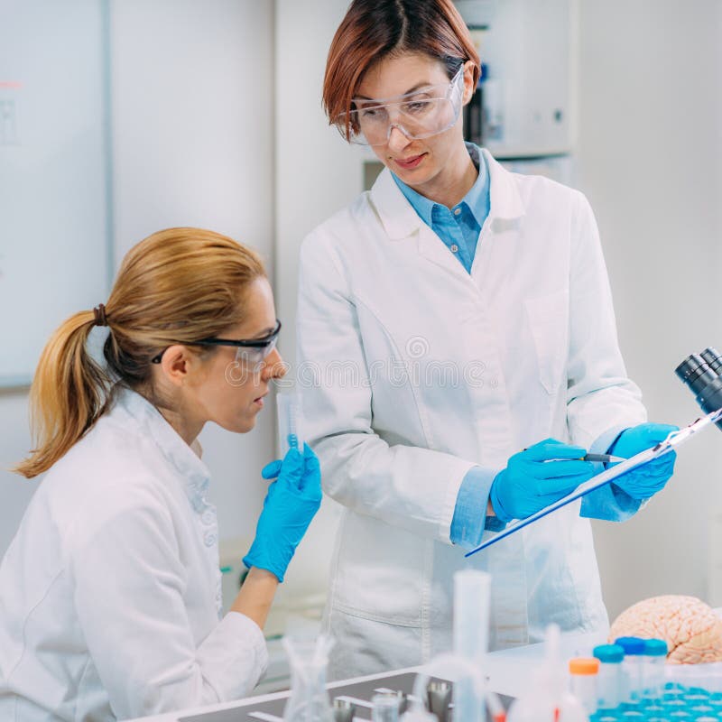 Olfactory Test in the Lab. Female Scientists Smelling a Sample in the ...