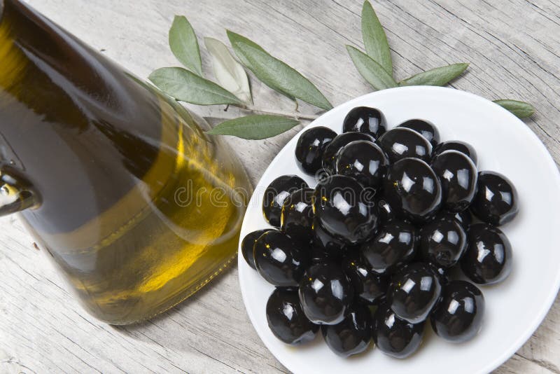 Olive Oil and a Plate with Black Olives. Stock Image - Image of leaves ...