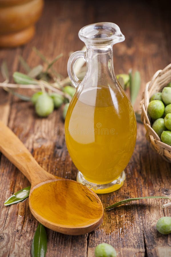 Olive oil on wooden table stock photo. Image of bottle - 99758384
