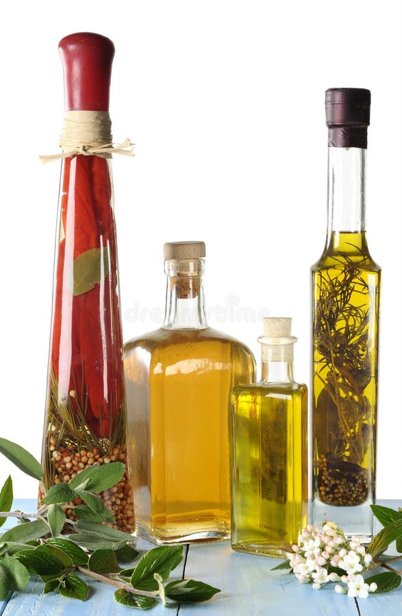 Olive Oils on a Blue Wooden Table with Herbs Stock Image - Image of ...