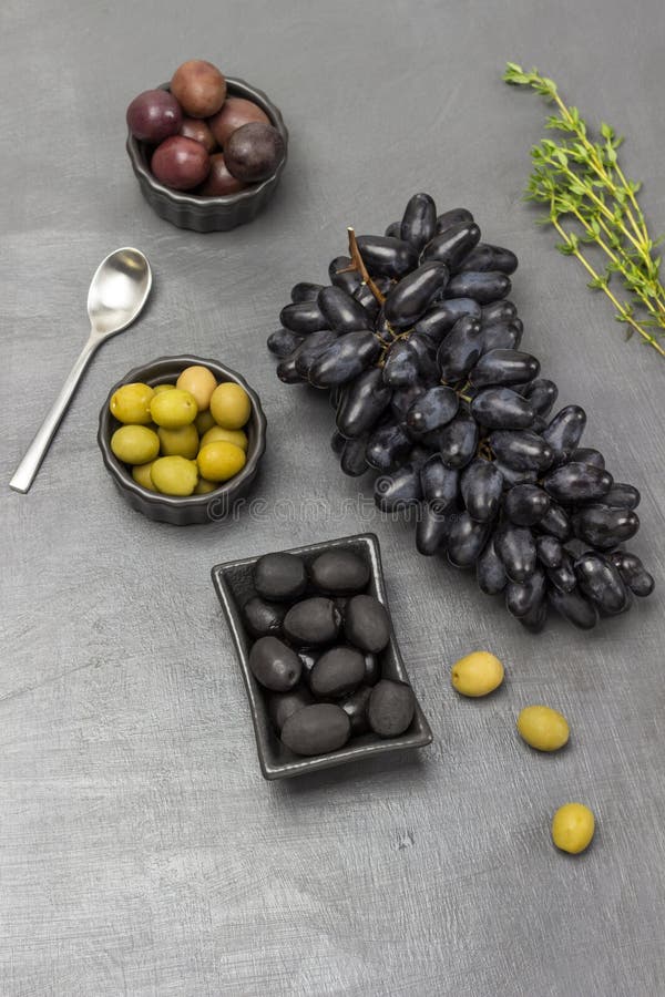 Olives in Bowls. Bunch of Black Grapes, Sprig of Thyme and Spoon on ...