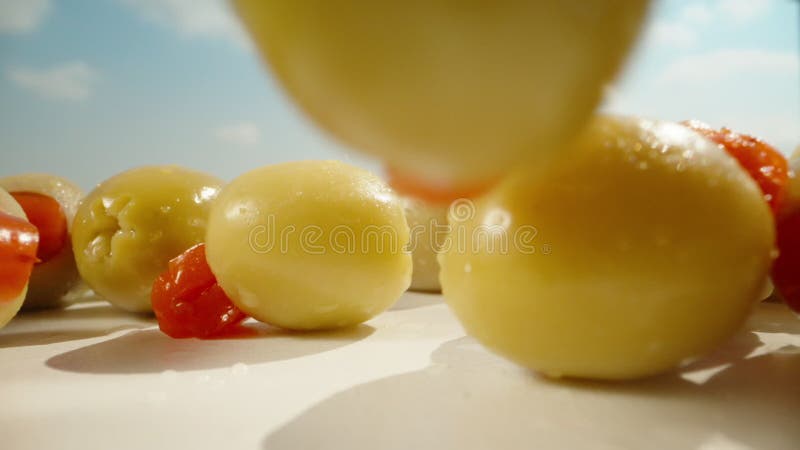 Olives with Pepper Inside, Against the Blue Sky, Fall on the Table ...