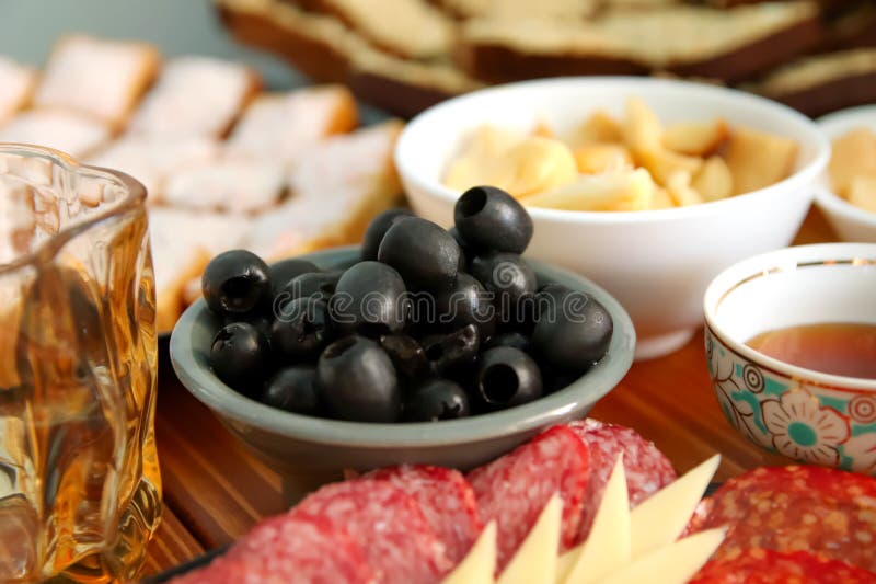 Olives, Sausage, and Cheese Arranged on a Serving Dish with Honey on a ...
