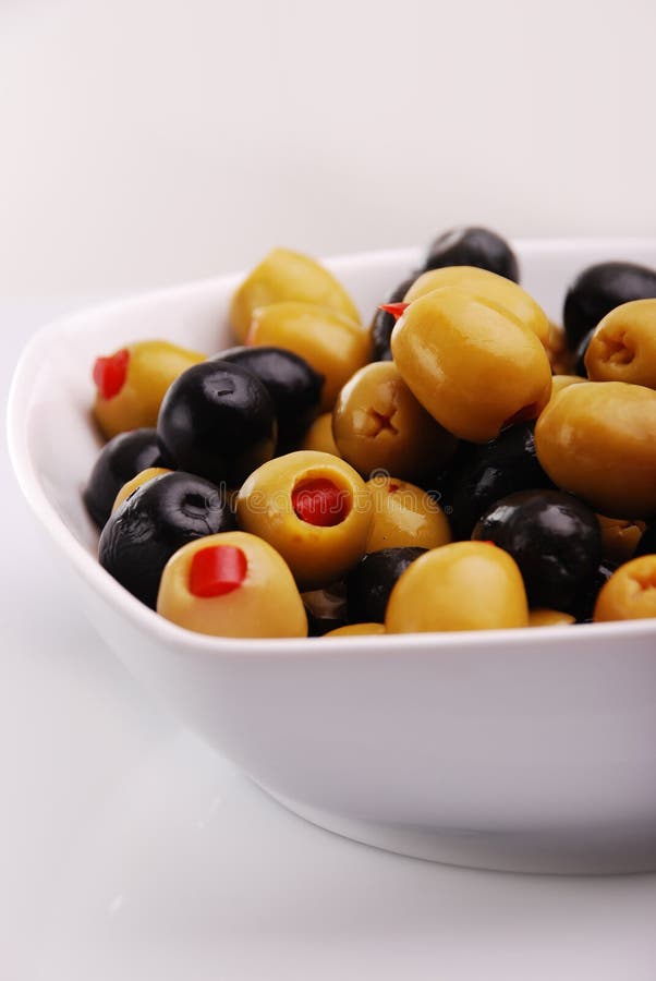 Olives, with red peppers stock image. Image of dish - 148803975