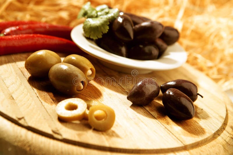 Olives on a wooden board stock photo. Image of mediterranean - 10866994