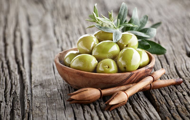 Olives on a wooden board stock image. Image of plate - 105124283