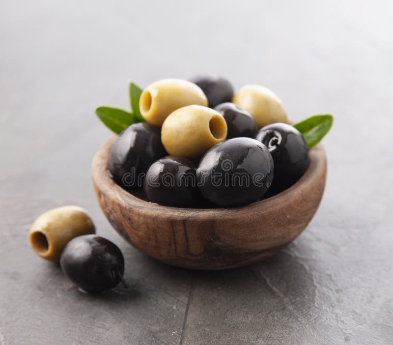 Olives in wooden plate stock photo. Image of nature - 254543140
