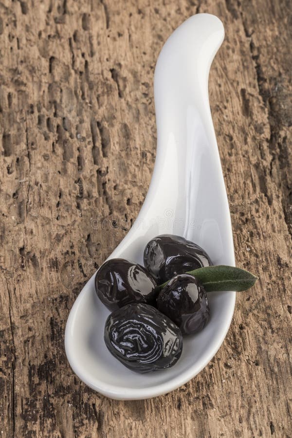 Olives on wooden table stock image. Image of mediterranean - 83221081