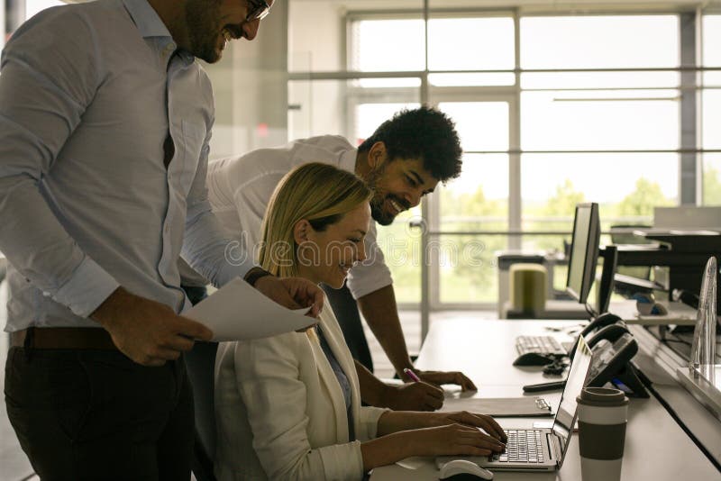 .olleague in Office Using Computer an Checking Document. B Stock Photo ...