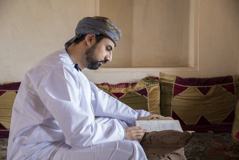 Arab Man in Traditional Omani Outfit Reading a Book Stock Image - Image ...