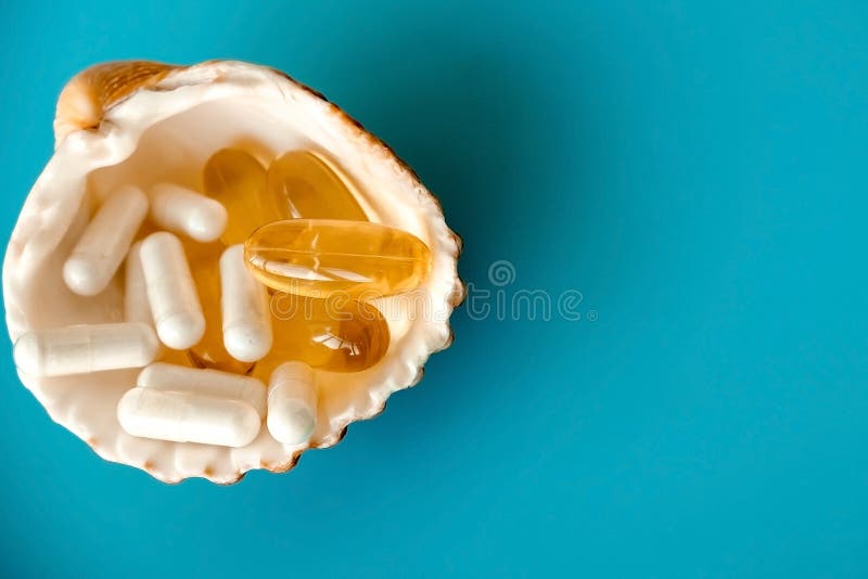 Omega 3 and Vitamin D Capsules on Shell, Fish Oil Pills Stock Photo ...