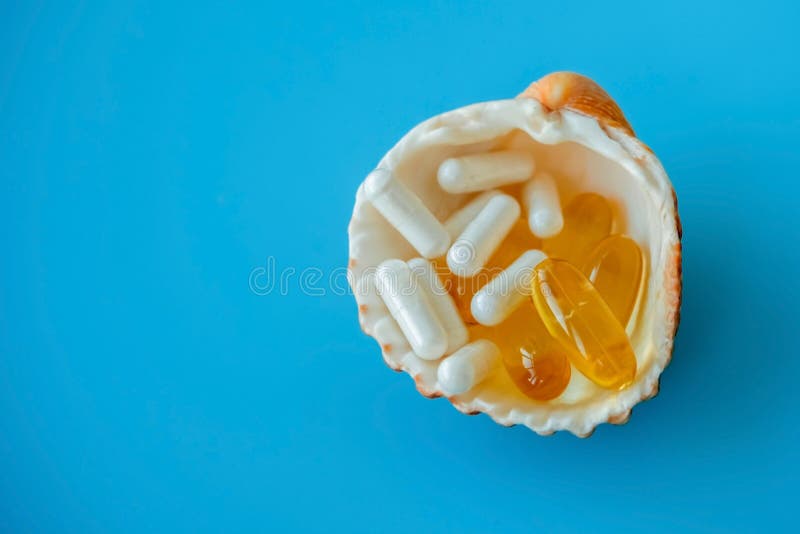 Omega 3 and Vitamin D Capsules on Shell, Fish Oil Pills Stock Image ...