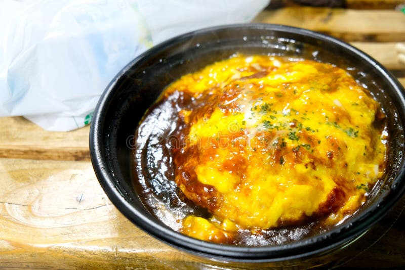 Omelet with Cheese and Sauce on Rice in Black Take Away Bowl Stock ...