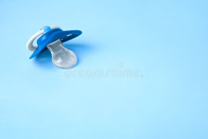 One Baby Pacifier on Light Blue Background. Space for Text Stock Photo ...