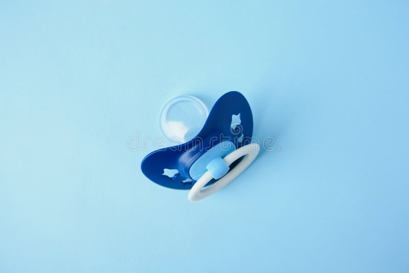 One Baby Pacifier on Light Blue Background, Top View Stock Photo ...