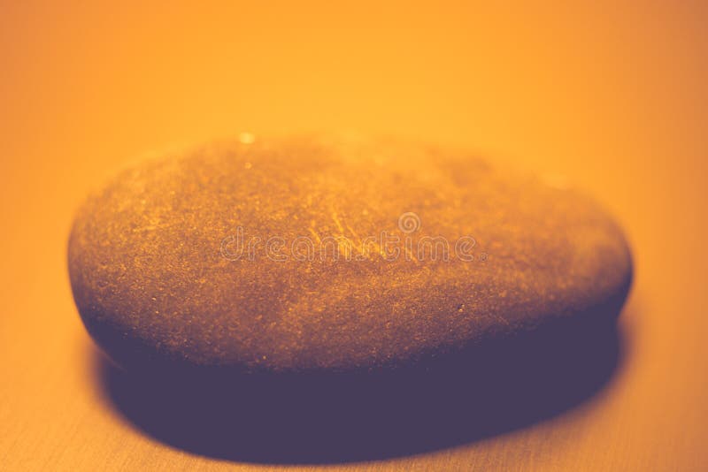 One Big Pebble Stone on the Table, Orange Light Stock Photo - Image of ...