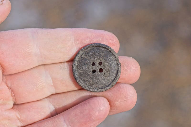 One Big Round Plastic Black Button Lies on the Fingers Stock Photo ...