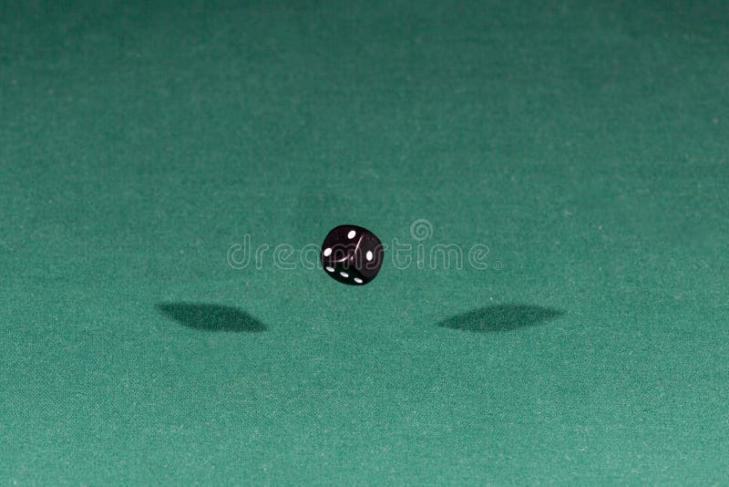 One Black Dice Falling on a Green Table Stock Photo - Image of gaming ...