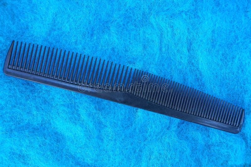 A Black Plastic Comb Rests on Blue Wool Stock Photo - Image of hair ...
