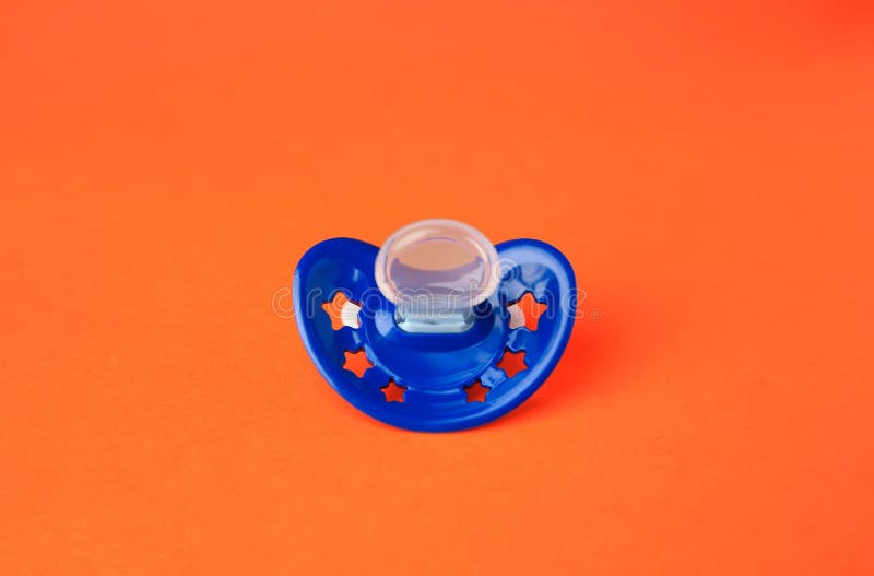 One Blue Baby Pacifier on Orange Background Stock Photo - Image of ...