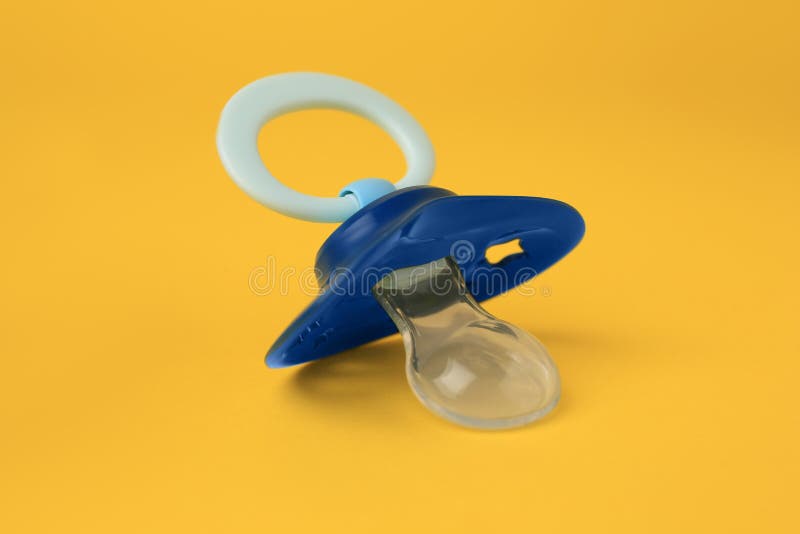 One Blue Baby Pacifier on Orange Background, Closeup Stock Image ...