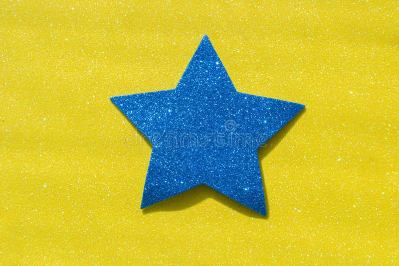 One Blue Big Star on a Yellow Shiny and Sparkling Background Stock ...