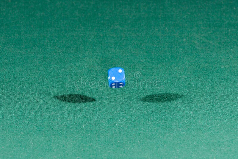 One Blue Dice Falling on a Green Table Stock Photo - Image of closeup ...