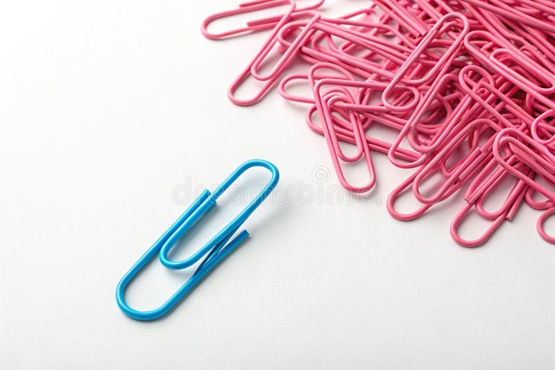 One Blue Paper Clip and Pile of Pink Paper Clips - Generated by Ai ...