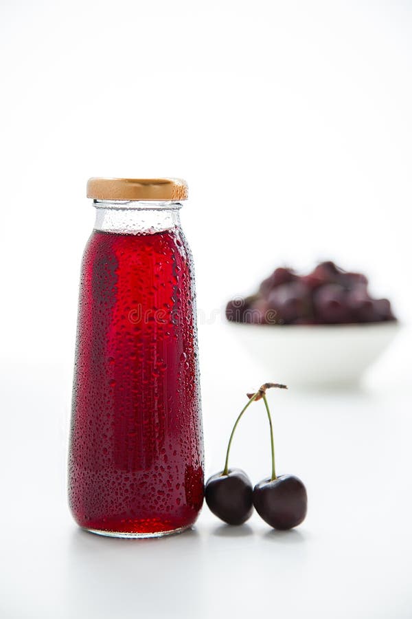One Bottle of Cherry Juice and Fresh Cherry on White Background Stock ...