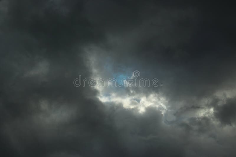 One Bright Spot Dark Clouds with a Little Bit of Blue Sky Stock Image ...