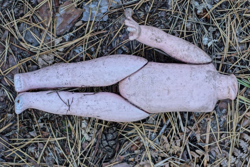 One Broken Old Dirty Plastic Doll Toy without a Head Lies on the Ground ...
