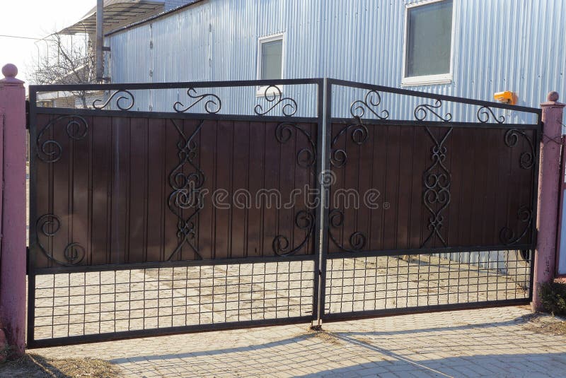 Brown Metal Closed Gate in the Street Stock Photo - Image of gate, gray ...