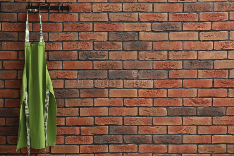 One Chef S Apron Hanging on Brick Wall, Space for Text Stock Photo ...