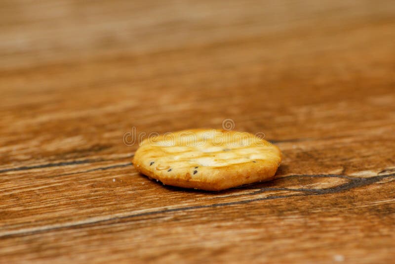One Circular Shaped Cracker on a Wooden Table Stock Photo - Image of ...