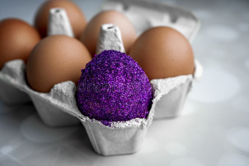 One Colored Egg among the Uncolored on a Package Container. Trendy ...