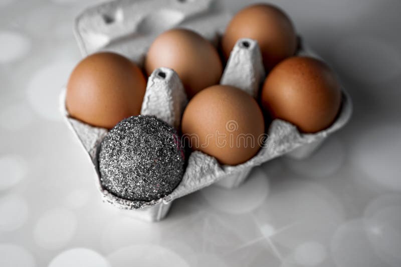One Colored Egg among the Uncolored on a Package Container. Trendy ...