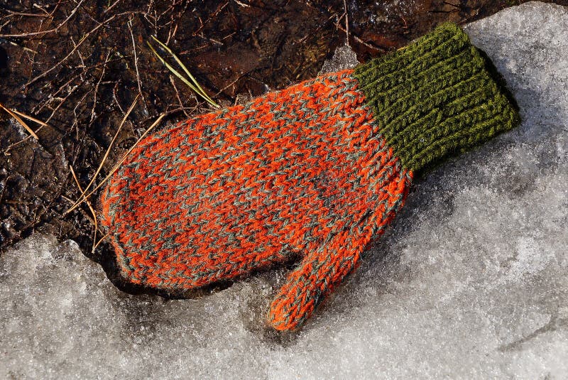 Colored Wool Mitten Lies on White Snow and Earth Stock Photo - Image of ...