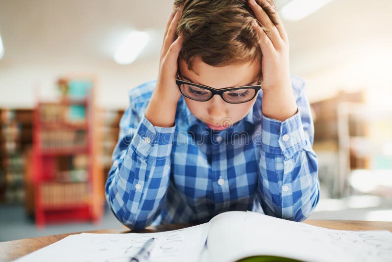 This One is Difficult. a Young Boy Looking Stressed Out while Working ...