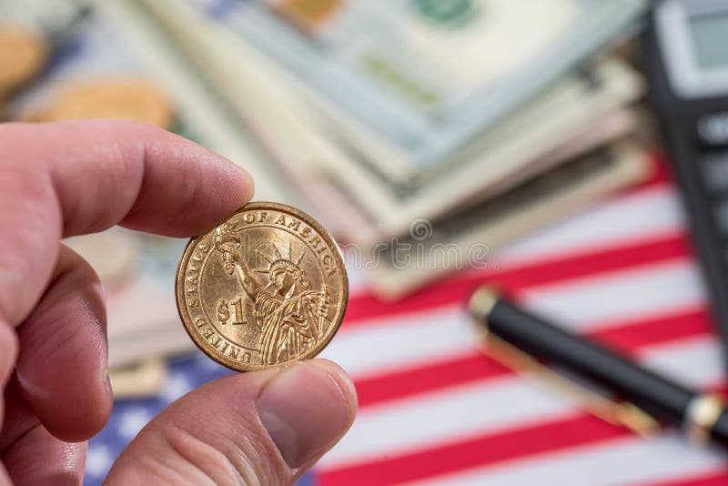 One dollar coin in hand stock photo. Image of fingers - 83246666