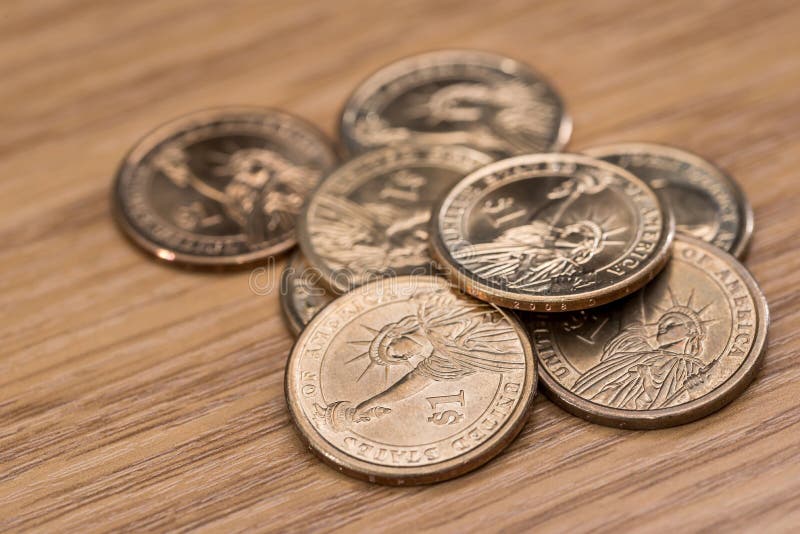 One Dollar Coin on Wooden Desk. Stock Image - Image of wooden ...